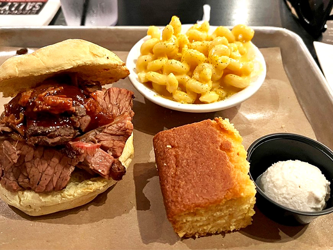 The brisket sandwich with mac and cheese and cornbread is the comfort food trifecta that makes Monday meetings bearable.