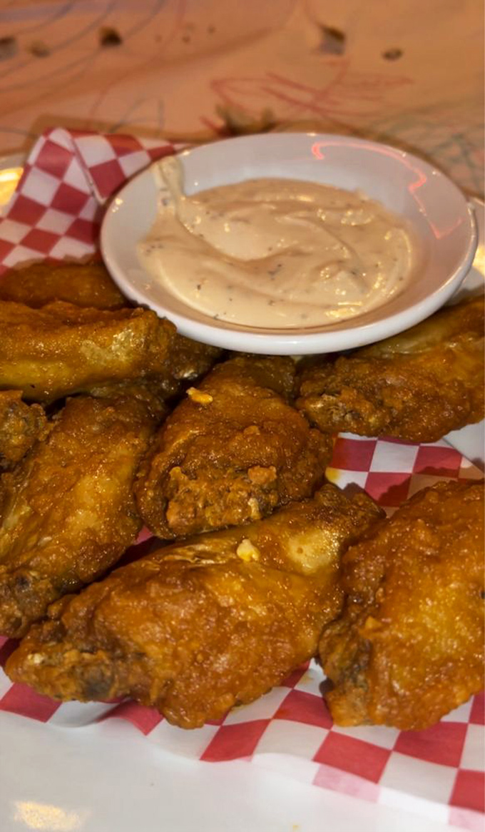 Golden-fried Buffalo wings arrive with dipping sauce, proving that sometimes the appetizer deserves just as much respect as the main event.