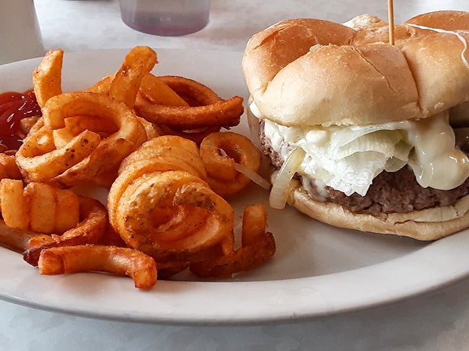 The burger that launched a thousand napkins. Melted cheese, grilled onions, and a bun that's somehow both soft and sturdy.