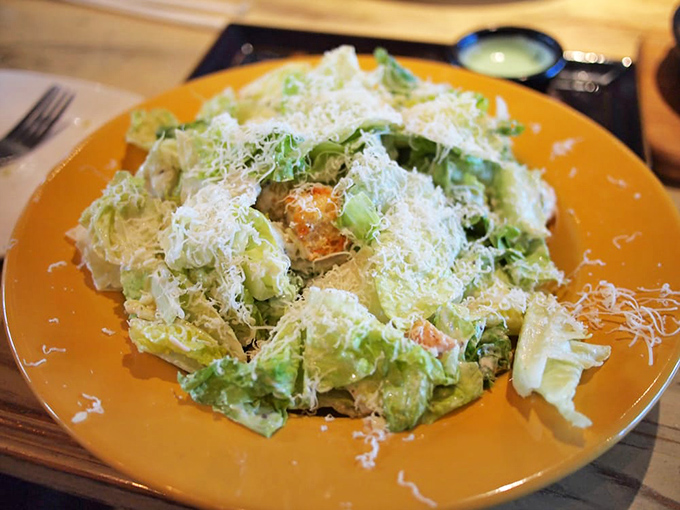 A Caesar salad that means business &ndash; crisp romaine dressed generously and showered with enough parmesan to make an Italian grandmother nod approvingly.