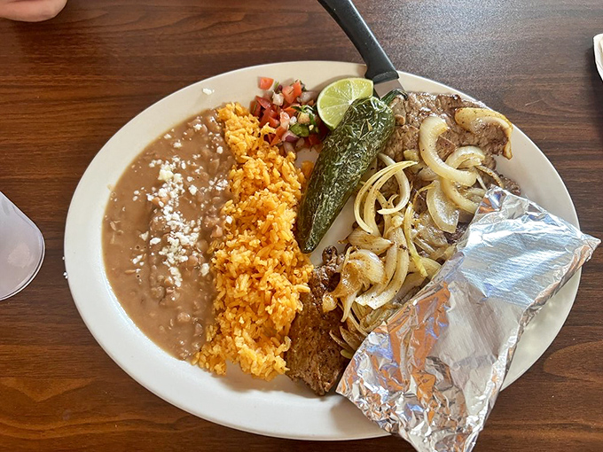 Carne asada with all the fixings&mdash;a plate that requires strategic eating and possibly a nap afterward. Worth every delicious, protein-packed bite.