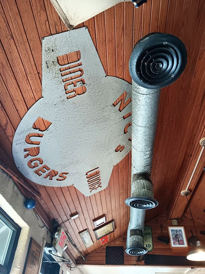 The metal burger silhouette hanging from the ceiling isn't just decor&mdash;it's a beacon guiding hungry pilgrims to their meaty destiny.
