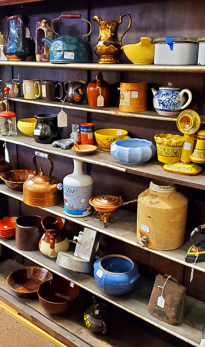 Teapots, pitchers, and vessels of every hue line these shelves like a ceramic rainbow. That blue teapot is practically begging to come home with me.