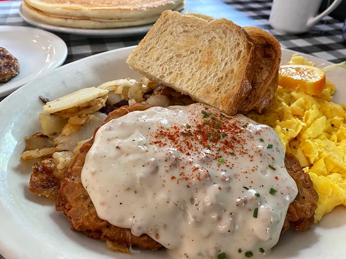 Chicken fried steak wearing its gravy like a winter coat&mdash;comfort food that doesn't just hug you, it envelops you in a full-body embrace.