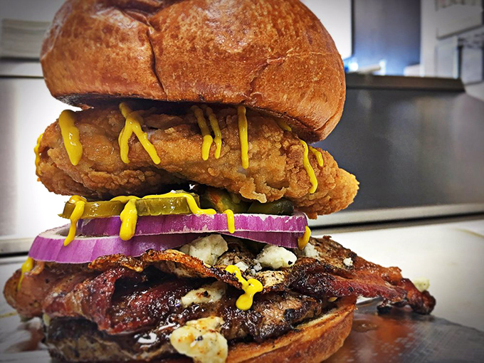 This towering creation defies both gravity and expectations. Crispy chicken, bacon, and that drizzle of mustard create a flavor skyscraper worth climbing.