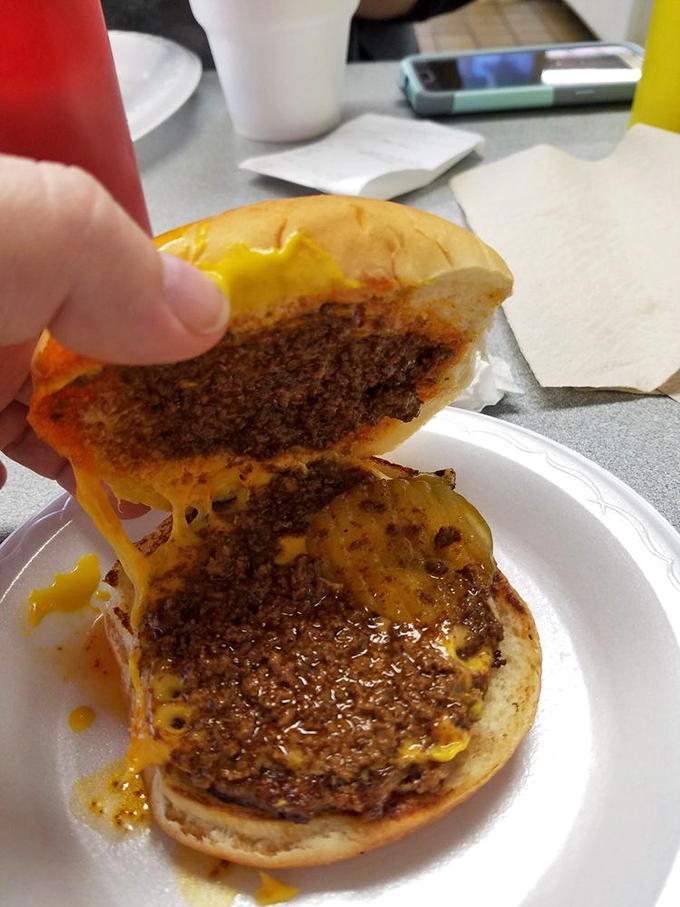 The cross-section reveals the true art form&mdash;melted cheese cascading into that signature chili. It's not just a burger, it's an engineering marvel.