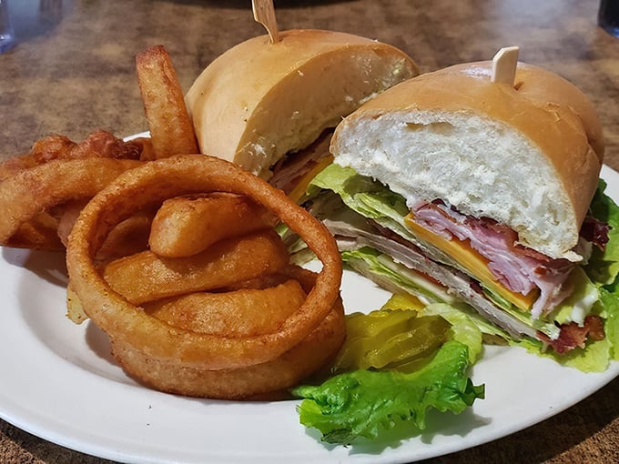 The club sandwich stands tall and proud, while those onion rings could double as delicious golden bracelets if they weren't so irresistible.