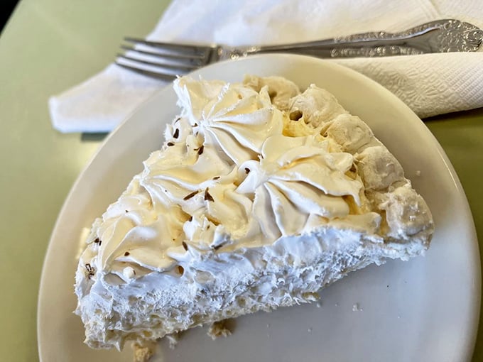 Coconut cream pie with meringue so high it needs FAA clearance. This isn't dessert&mdash;it's an engineering marvel with a sweet disposition.