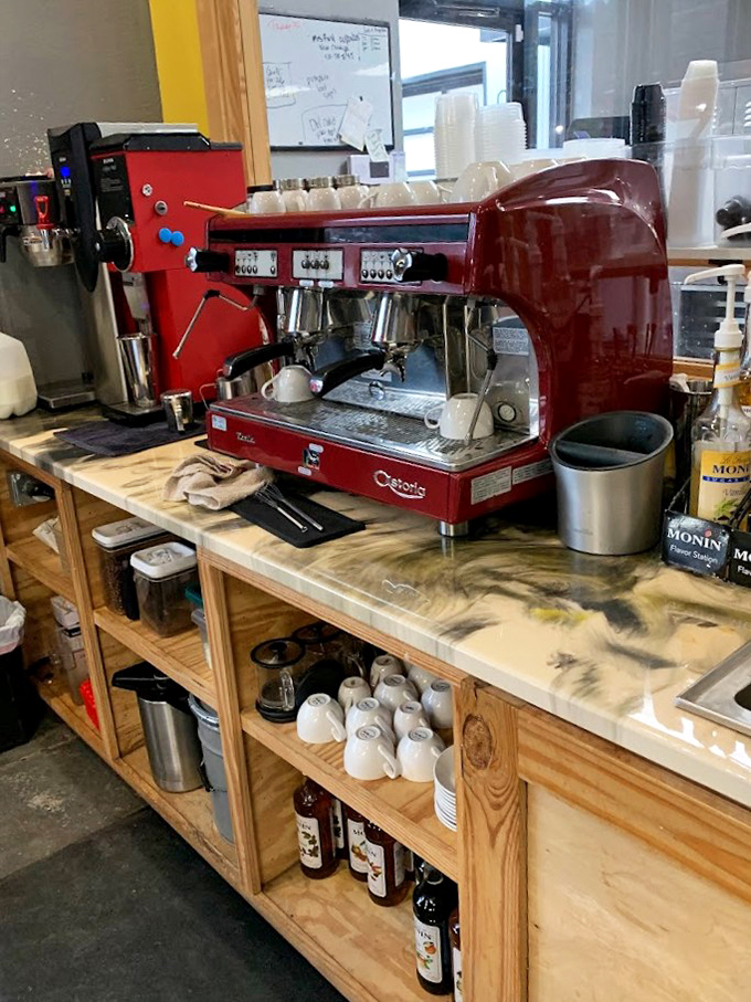 The gleaming red espresso machine stands ready for duty like a Ferrari in a garage &ndash; powerful, beautiful, and dedicated to delivering peak performance.
