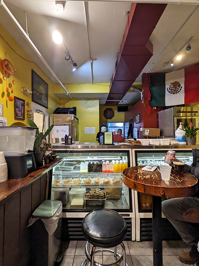The counter setup is no-nonsense, just like their approach to food. Yellow walls and a Mexican flag remind you that authenticity isn't just a buzzword here.