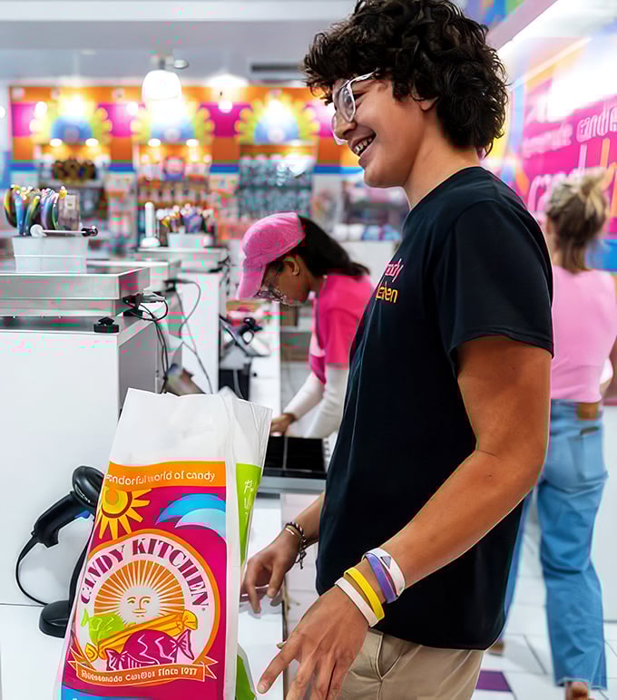 The smile of someone who's just exchanged actual currency for permission to eat like a unsupervised eight-year-old. Worth every penny.