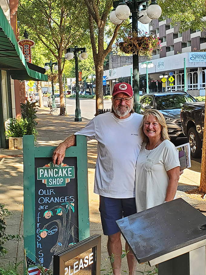 The sign outside promises fresh oranges, and these happy customers found that and more &ndash; the universal expression of post-pancake satisfaction.