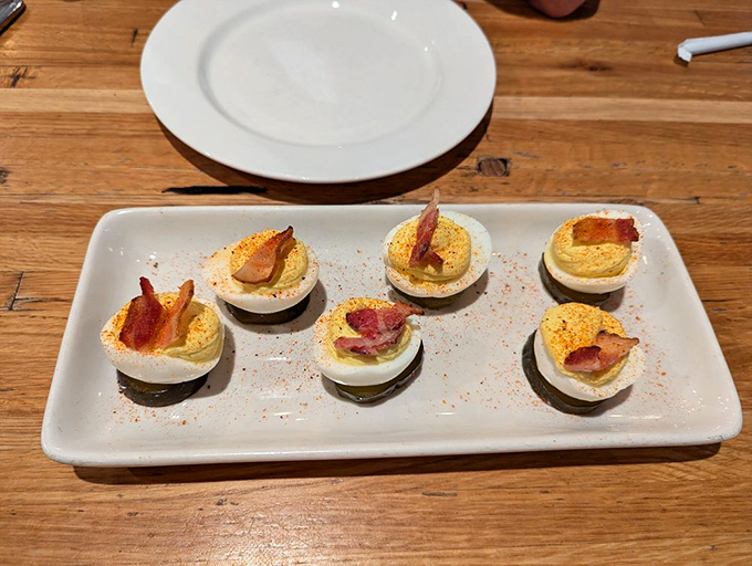 Deviled eggs topped with bacon&mdash;because sometimes traditional appetizers need a smoky makeover to fit into the barbecue family.