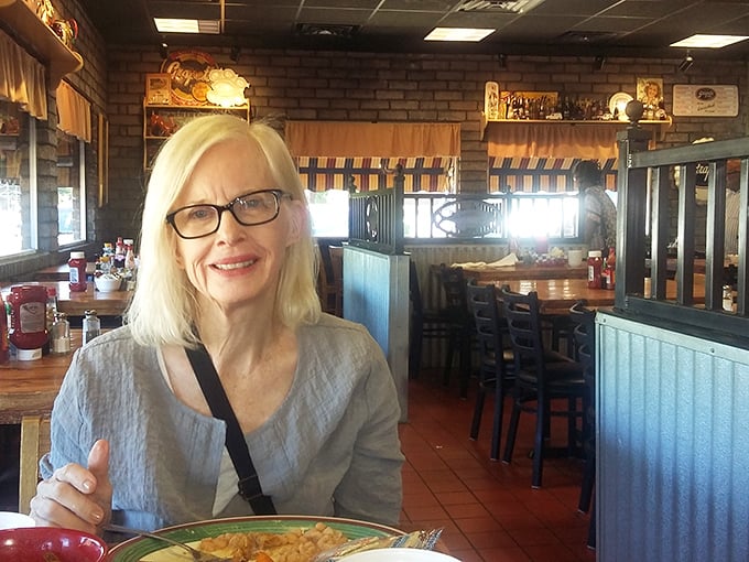 The dining room balances rustic charm with practical comfort &ndash; brick walls and wooden dividers creating little pockets of conversation and community.