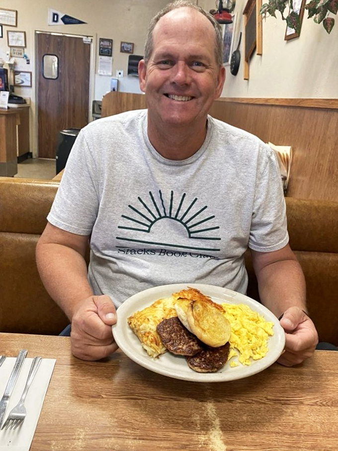 A happy diner with a plate of breakfast bliss. That smile says everything you need to know about what's happening on that plate.