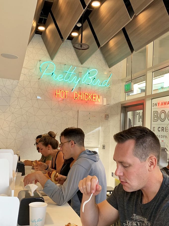 The focused expressions of diners under that iconic neon sign tell you everything. Nobody talks during the first bite at Pretty Bird&mdash;it's a moment of silent reverence.