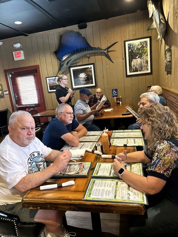 Locals gather under mounted sailfish, proving that at Cross Creek, good food brings together folks from all walks of Jacksonville life.