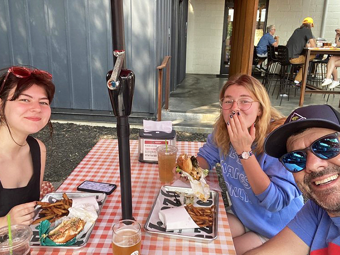 The universal language of "first bite face"&mdash;that moment when you realize this burger journey was absolutely worth the trip.