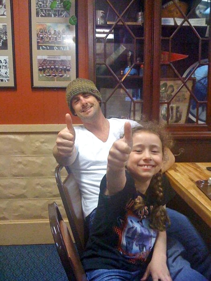 The universal language of barbecue satisfaction: thumbs up from happy customers who've just experienced meat nirvana in Shawnee.