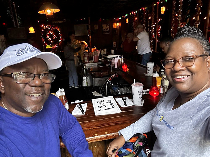 Happy diners experiencing what many locals consider a required pilgrimage on any proper New Orleans itinerary.