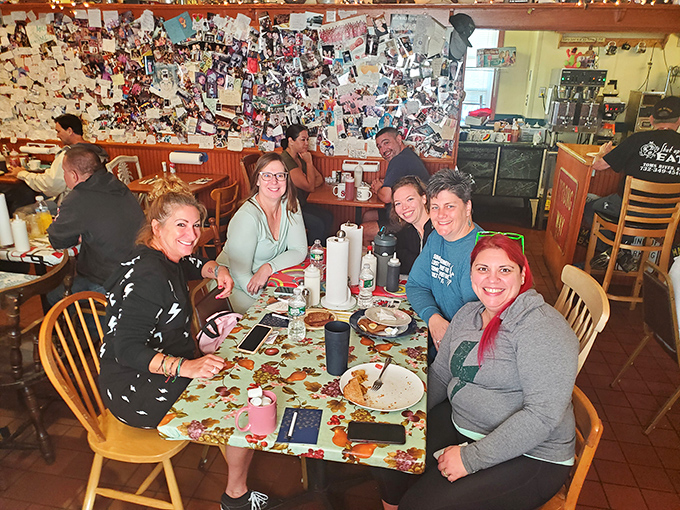 Happy diners gathered around a table of demolished plates. The universal language of "that was worth every calorie" needs no translation.