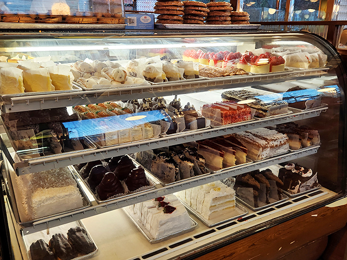 The dessert case is basically an edible art gallery—a display of towering cakes and pies that makes willpower crumble faster than their perfect pie crusts.