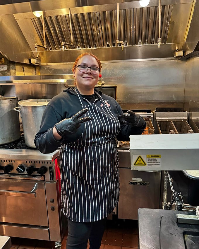 Behind every great BBQ joint is a team of dedicated flavor wizards. Those gloves have touched more happiness than Santa Claus.