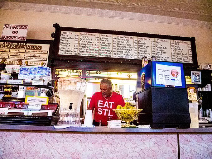 Behind every great soda fountain is someone who knows the difference between serving food and preserving a tradition. The "EAT STL" shirt says it all.