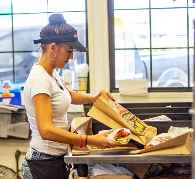 Behind every legendary sandwich is someone who crafts it with care, wrapping Oklahoma tradition in paper with practiced hands.