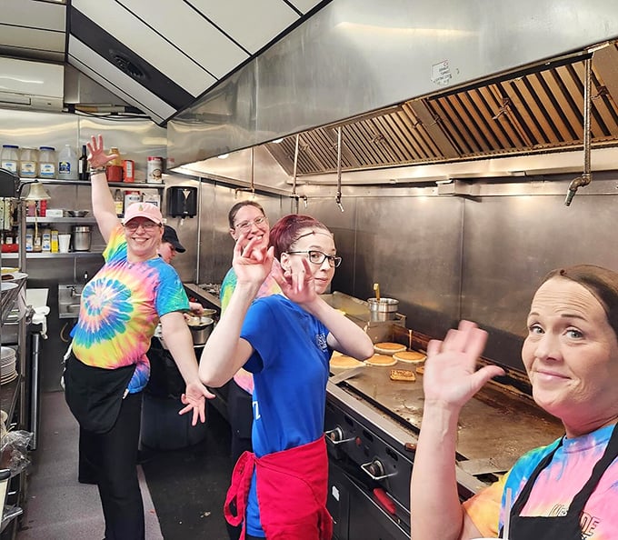The kitchen crew waves with the confidence of people who know they're responsible for the happiness of everyone in a five-mile radius.