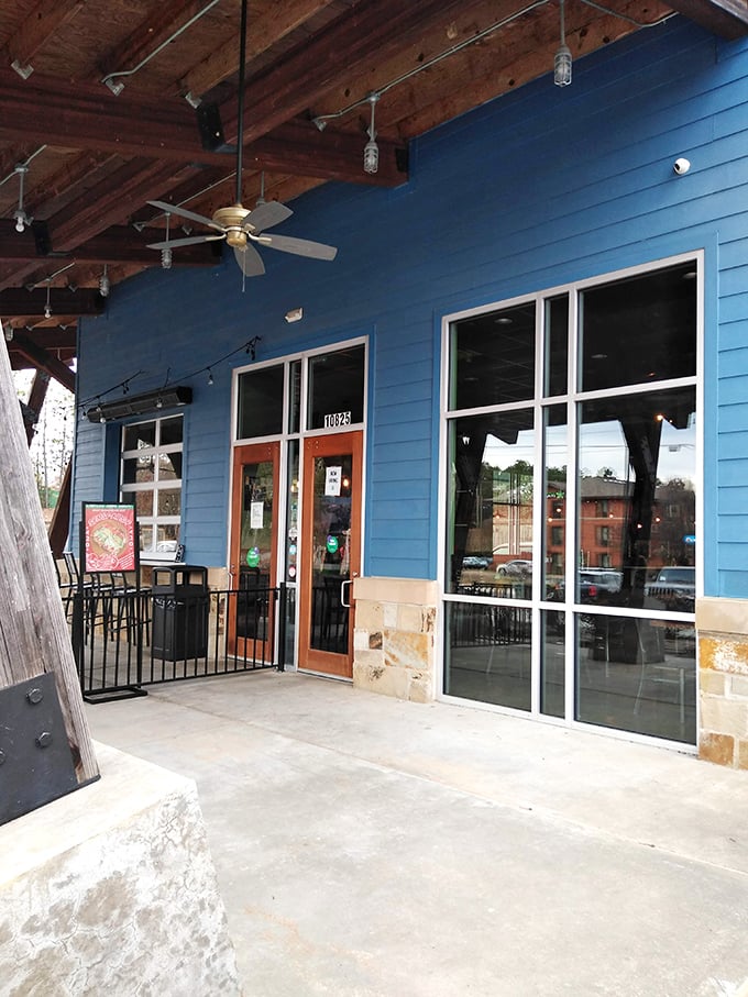 The entrance beckons like a blue sandwich temple. Those wooden beams aren't just support&mdash;they're setting expectations for what's inside.