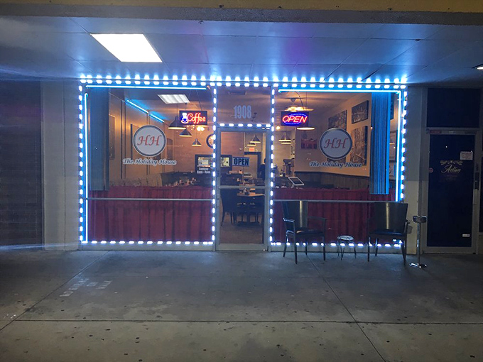 As evening falls, the Holiday House's blue lights transform from diner to neighborhood lighthouse guiding the hungry home.