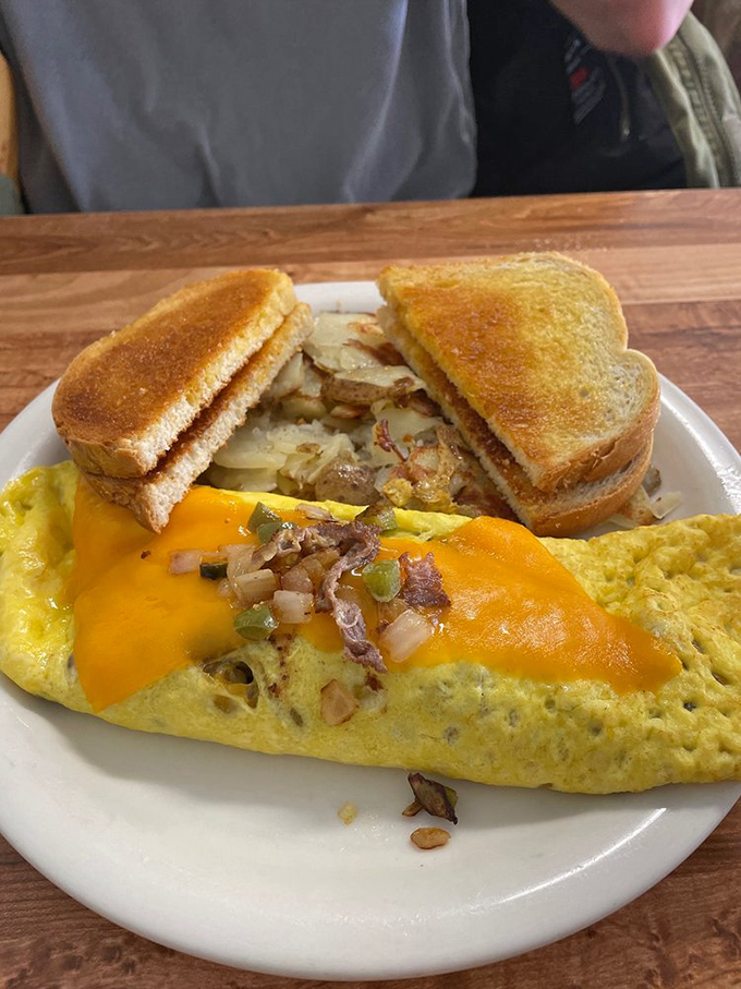 The Denver omelet that makes you wonder why you'd ever order anything else. That melted cheese is performing miracles right before your eyes.