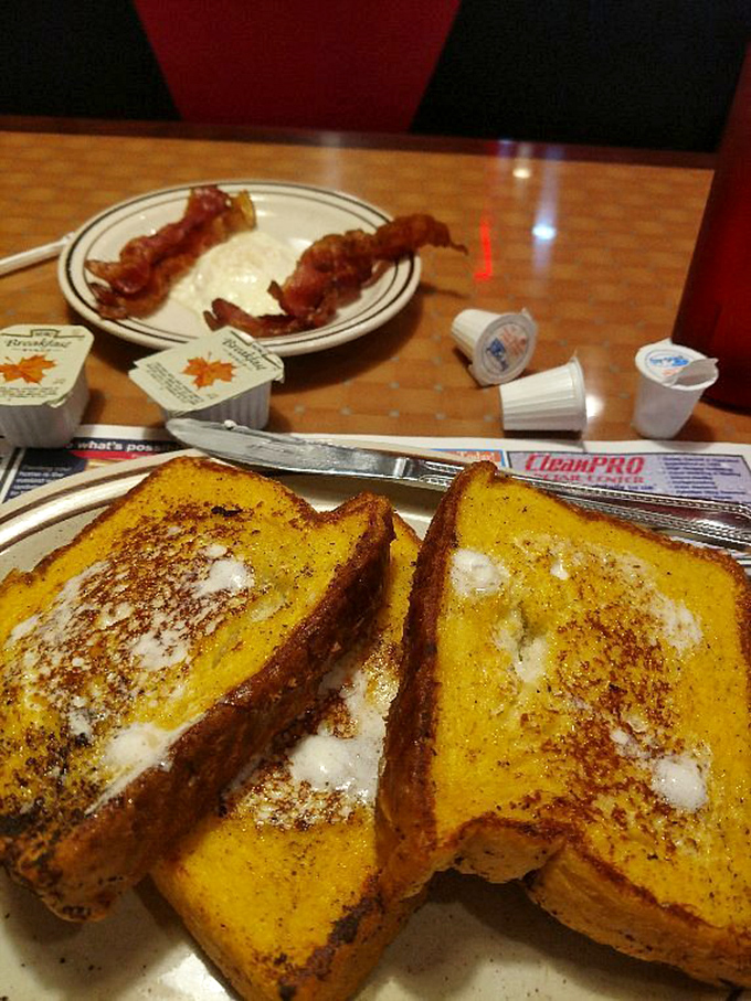 French toast that's achieved the golden-brown perfection we all attempt at home but rarely achieve. The melting butter creates little pools of weekend happiness.