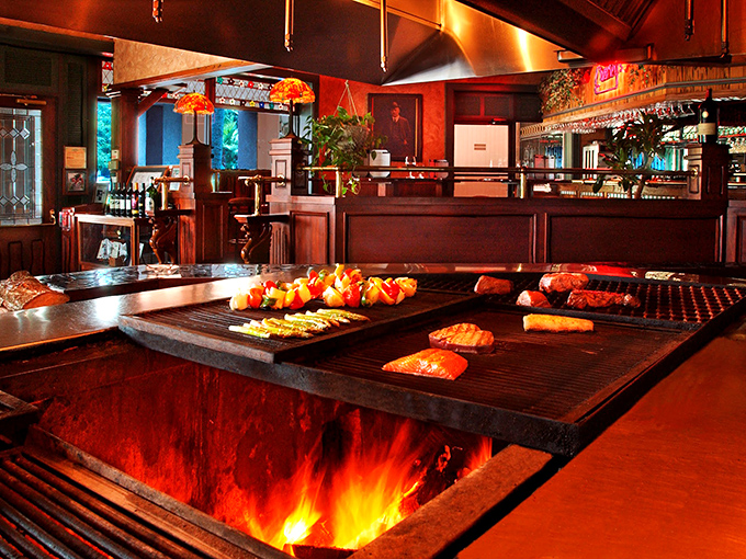 Where the magic happens! Flames leap dramatically as steaks sizzle on the open grill, a carnivorous theater of delicious proportions.