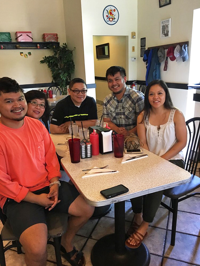 Happy diners sharing more than just a meal&mdash;they're collecting memories around a formica table. This is what restaurants are really about.