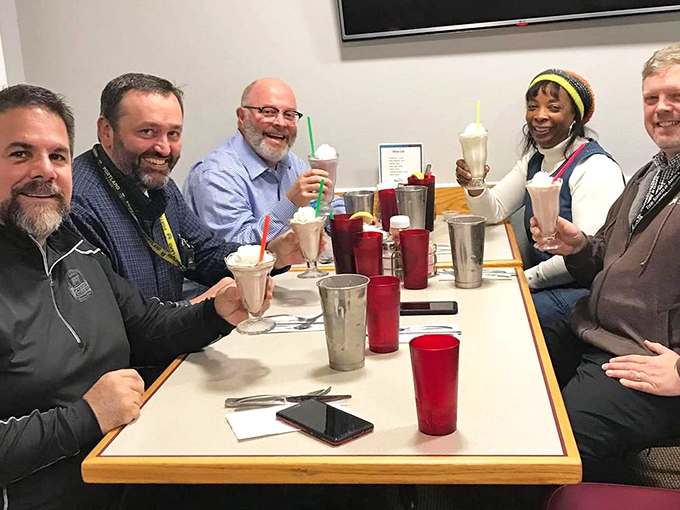 Nothing says "we found the good place" like a table of friends raising milkshakes in a toast to small-town culinary discoveries.