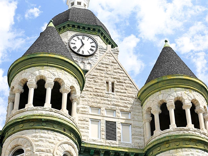 The courthouse clock tower stands as both timekeeper and architectural marvel, its limestone details showcasing craftsmanship rarely seen in modern buildings.