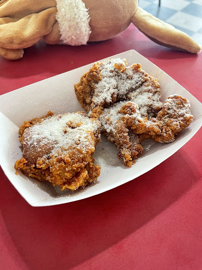 These powdered sugar-dusted fried chicken pieces aren't just food – they're little golden tickets to a moment of pure, unadulterated joy.