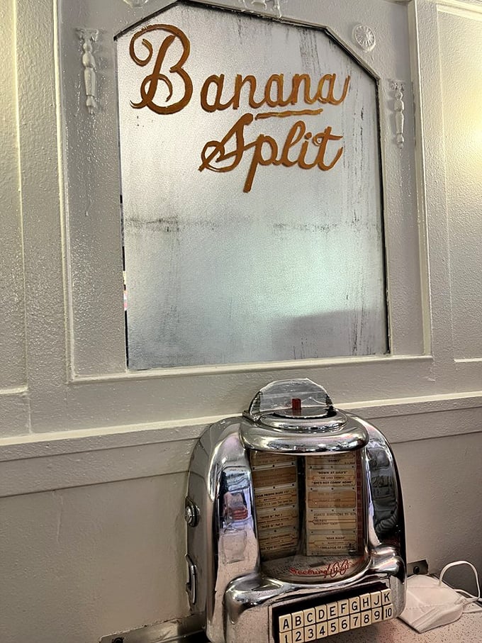 An antique jukebox selector sits beneath the hand-painted "Banana Split" sign—two American classics keeping each other company.