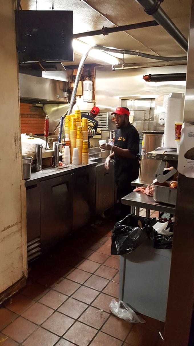 Behind the scenes, the magic happens. Red-capped maestros orchestrate the symphony of smoke and meat that's made Arthur Bryant's a landmark since the 1920s.