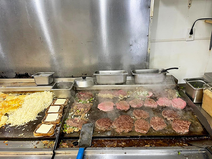 Where the magic happens! The grill sizzles with massive patties, each one destined for burger greatness and Instagram fame.