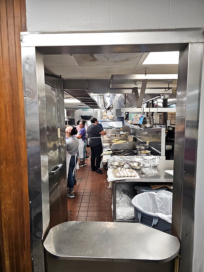 The kitchen view reveals the ballet behind the comfort—skilled hands that could make these dishes blindfolded after decades of muscle memory.