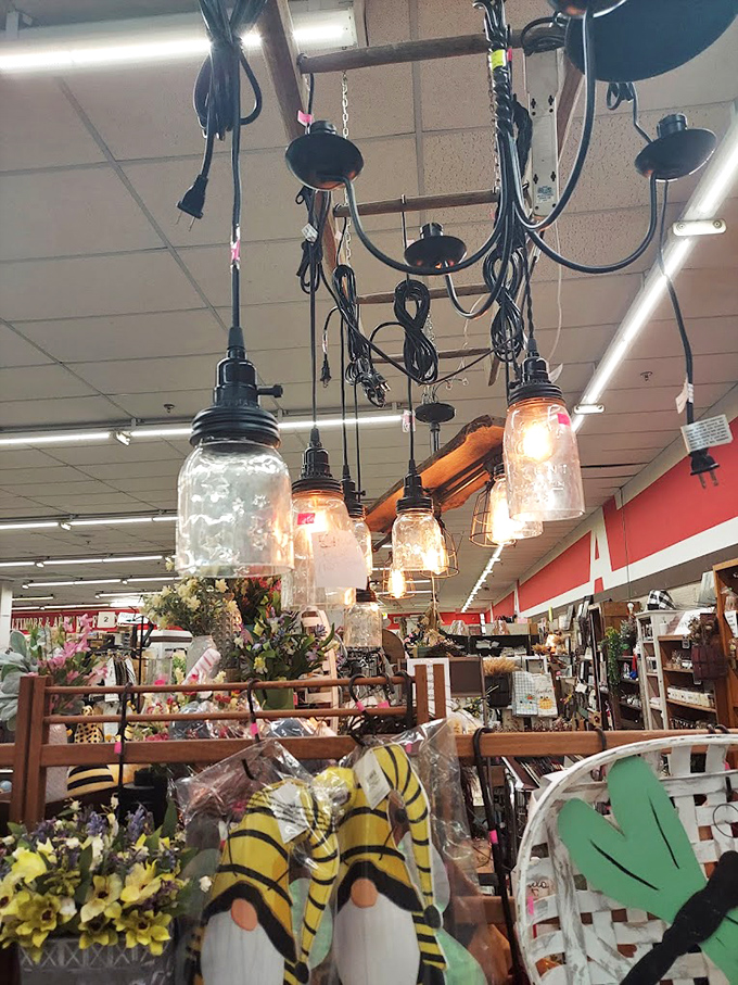 Mason jar chandeliers casting warm light over spring decorations. Farmhouse chic before HGTV made it a thing.