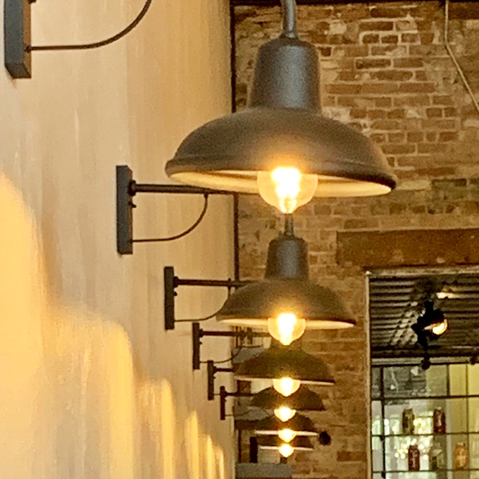 These industrial wall sconces against exposed brick create the perfect lighting to make both your food and your dining companion look ten years younger.