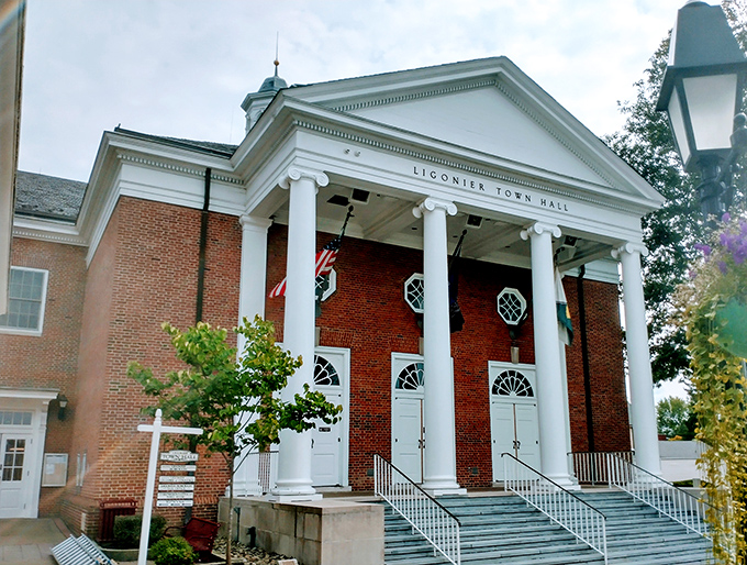 Ligonier Town Hall's imposing columns and stately brick construction remind visitors that even small-town governance deserves architectural grandeur.