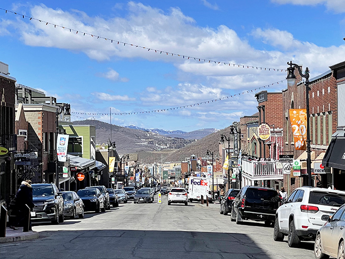 Main Street stretches toward the mountains like a runway, each storefront more inviting than the last. Window shopping becomes an Olympic sport here.