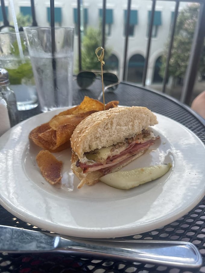 This muffuletta sandwich on the patio tells you it's not just about what's inside (though that's magnificent)&mdash;it's about taking your time with good food.