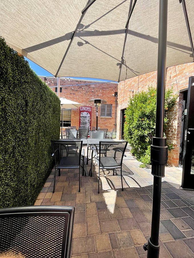 The outdoor patio offers a serene escape from Tucson's heat, with umbrellas providing shade for you and your chosen burger companion.