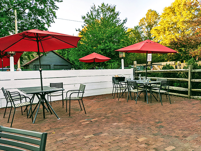 Outdoor seating with cheerful red umbrellas that pop against the brick patio. Even the fence looks like it's been there since Delaware became a state.